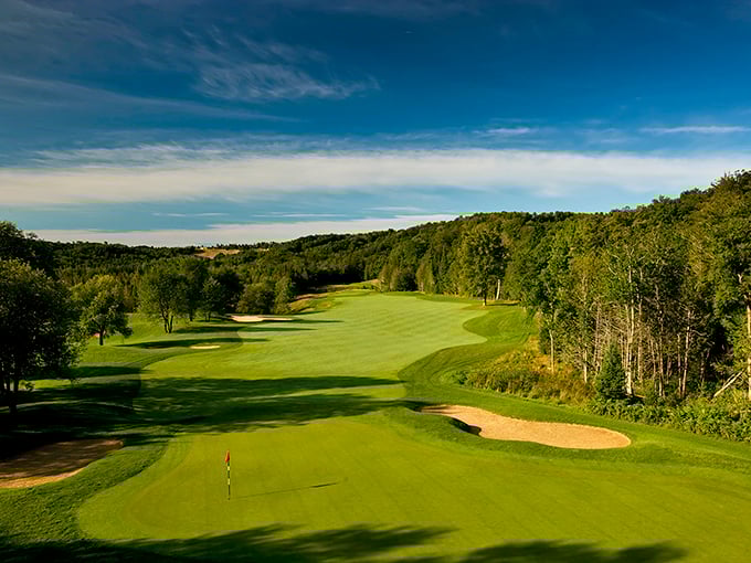 Otsego Club's pristine fairways roll through northern Michigan's landscape like nature's green carpet, tempting even non-golfers to grab a club.