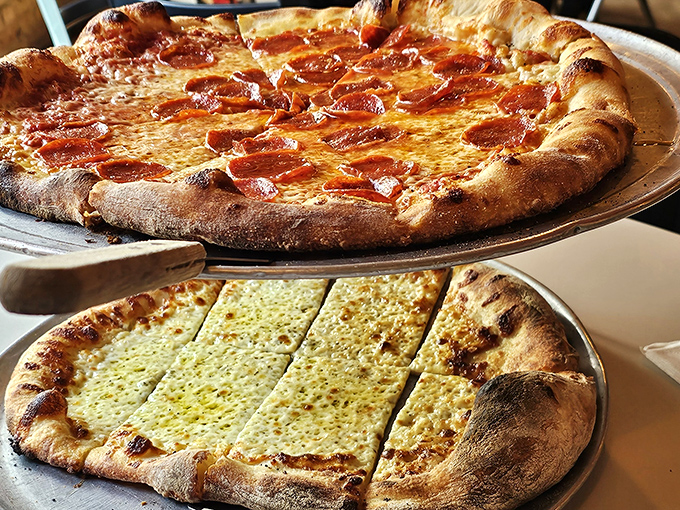 Pizza perfection on display: that pepperoni with its curled, crispy edges sits alongside cheese bread that's worth every carb-laden bite.