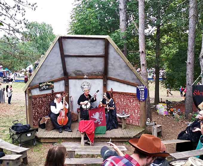 Musicians bring ancient melodies to life on a rustic stage, their authentic instruments and costumes creating an immersive historical soundscape.