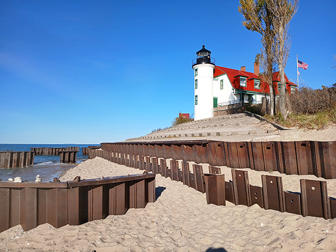 Point Betsie Lighthouse stands like a maritime sentinel, its red-capped tower a perfect contrast to the endless blue horizon beyond.