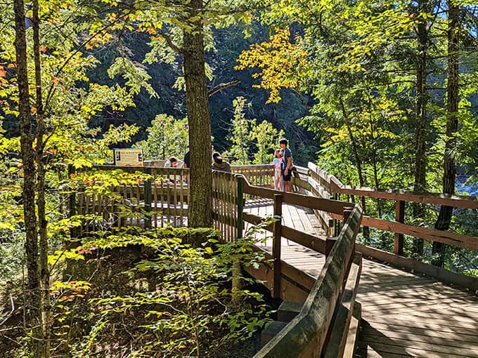 The wooden boardwalk invites visitors to pause and soak in the view – no admission ticket required for this natural theater experience.