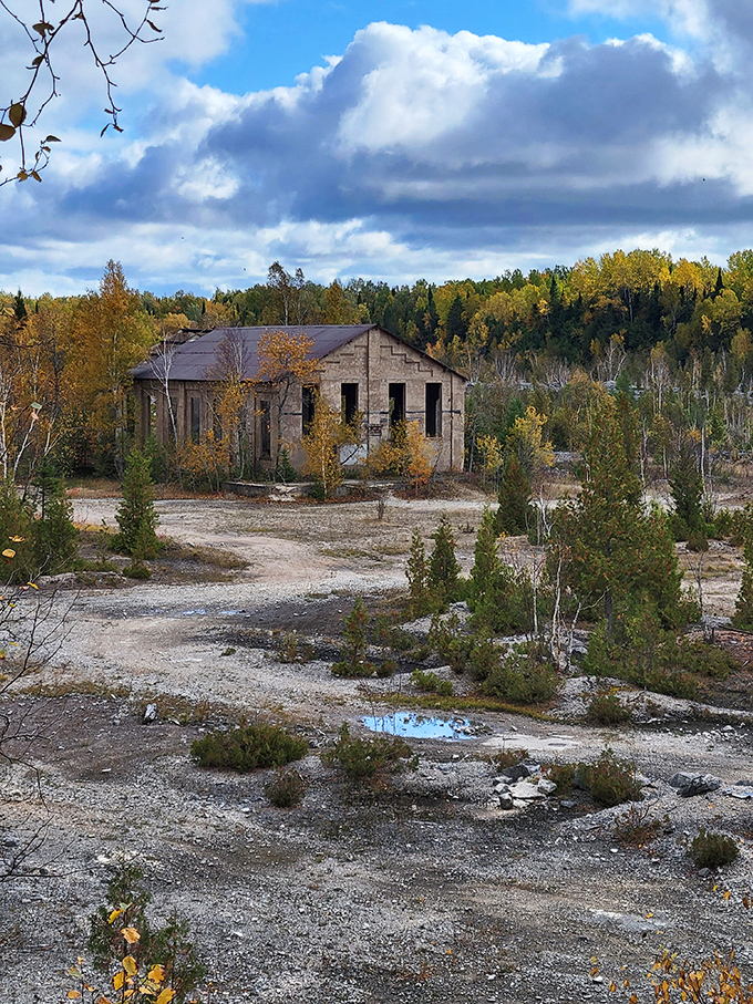 This abandoned powerhouse building now generates only memories, its weathered walls standing defiant against decades of Upper Peninsula seasons.