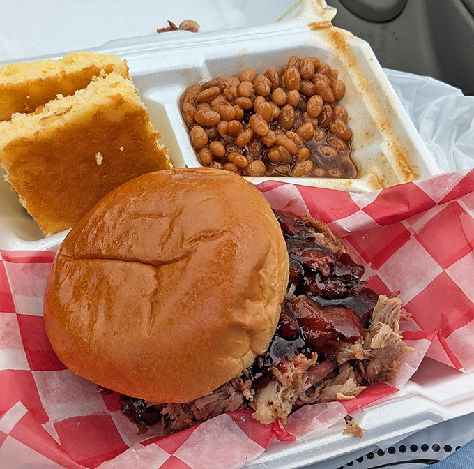 This pulled pork sandwich isn't just lunch – it's a religious experience between two buns that might make you weep tears of barbecue joy.