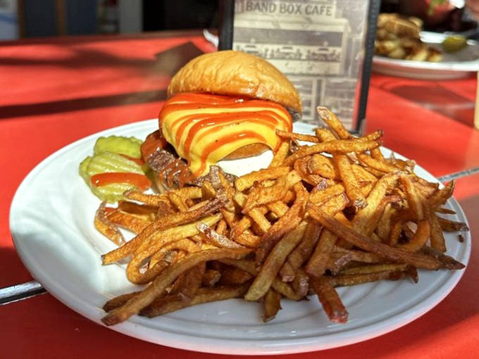 This isn't just a burger – it's edible architecture. Golden fries, melted cheese, and a perfectly cooked patty create a symphony of comfort.