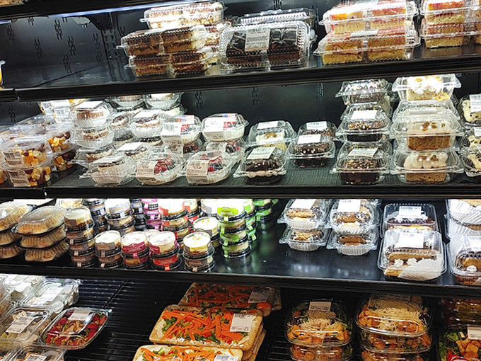 The dessert case showcases a dazzling array of treats, from homestyle cookies to elegant pastries, each one whispering, "Vacation calories don't count!"