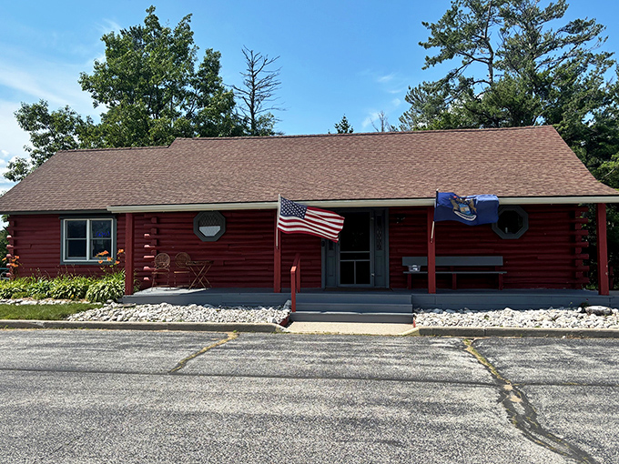 The rustic Schoolcraft County Welcome Center provides the perfect backdrop for its oversized guardian, inviting travelers to discover local treasures.