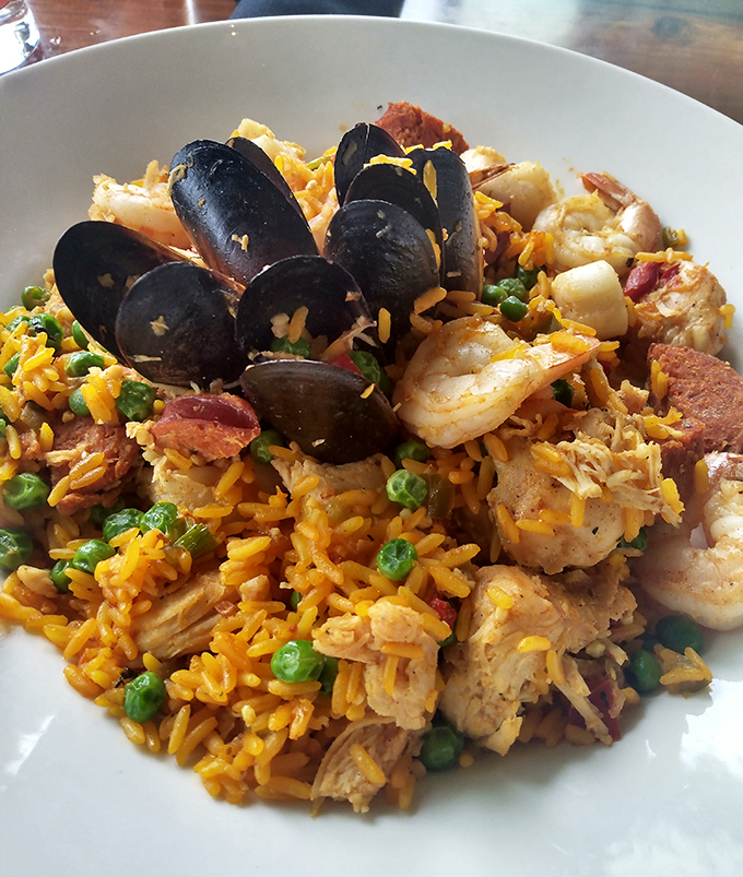 Seafood Paella that would make a Spanish grandmother nod in approval – a colorful fiesta of perfectly cooked treasures from the sea.