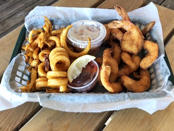Golden-fried shrimp that snap between your teeth, paired with curly fries that somehow taste better with sand between your toes.