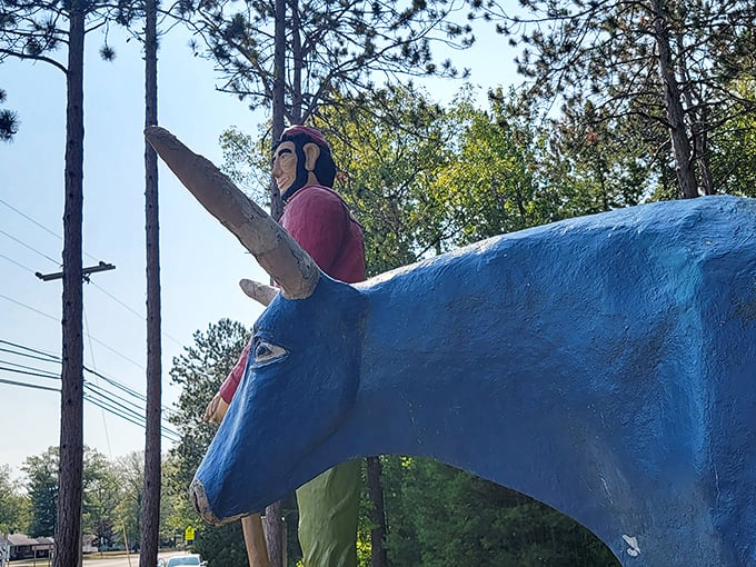 From this angle, you can see Paul's trusty companion Babe waiting patiently nearby, their friendship immortalized in vibrant paint and concrete.