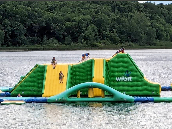 Yellow slides and green platforms create a water wonderland that beckons the brave and guarantees spectacular wipeouts for the overconfident.