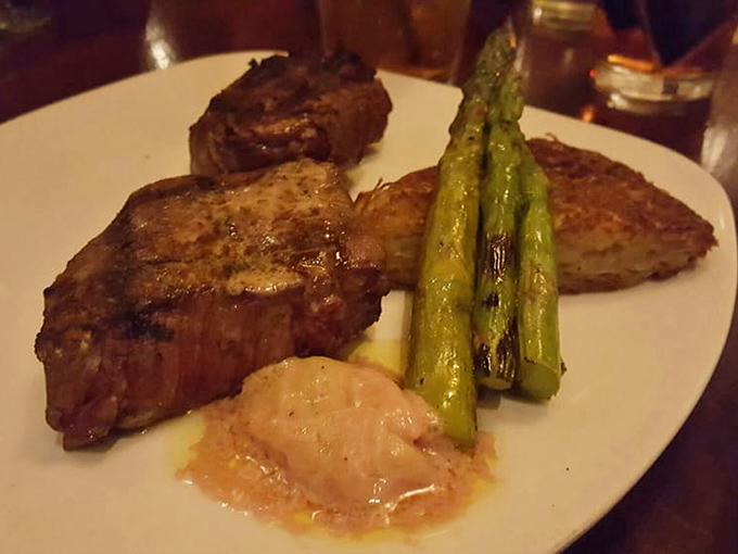A perfectly seared steak shares the spotlight with vibrant asparagus spears standing at attention – protein and vegetables in perfect harmony.