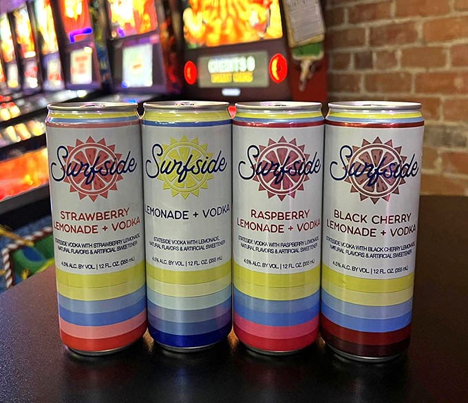 Surfside's colorful cans line up like digital power-ups, offering strawberry, lemonade, raspberry and black cherry vodka refreshment between gaming sessions.