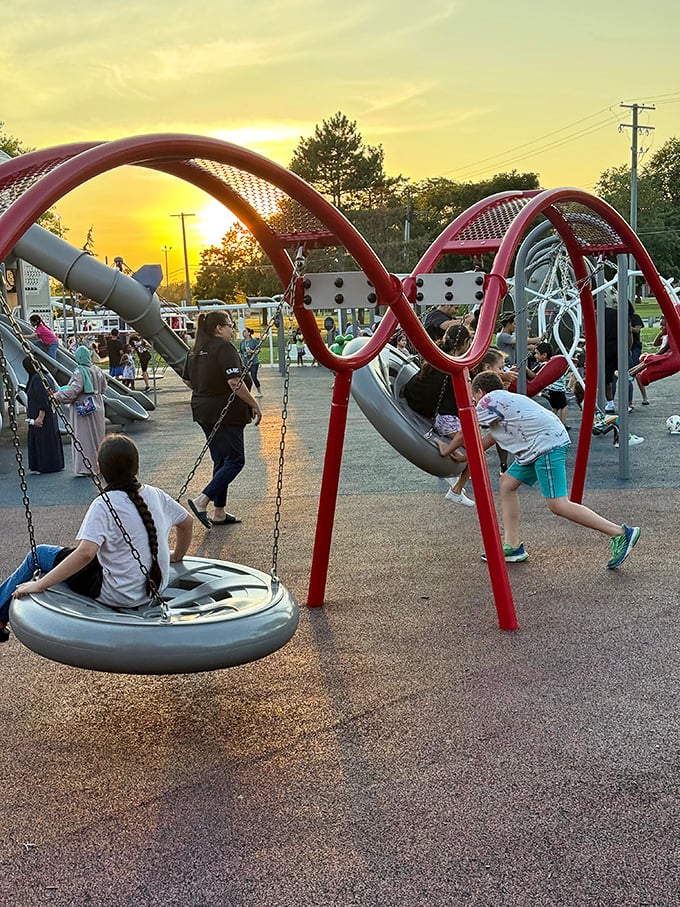Sunset casts a golden glow over the swing area, where traditional playground fun meets modern design &ndash; childhood's simple pleasures never looked so good.