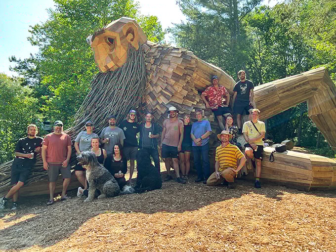 Visitors gather beside the gentle giant, providing scale that truly highlights the impressive 22-foot height of this remarkable sculpture.
