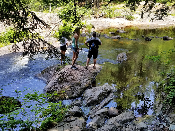 Three adventurers navigate the rocky terrain, proving that the best views require actual effort, not just good Wi-Fi.