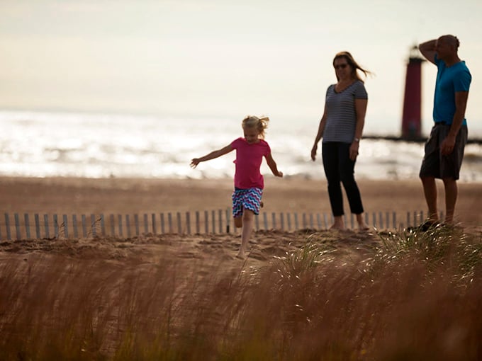 Families create lasting memories along the shoreline, where gentle waves make for kid-friendly swimming adventures.