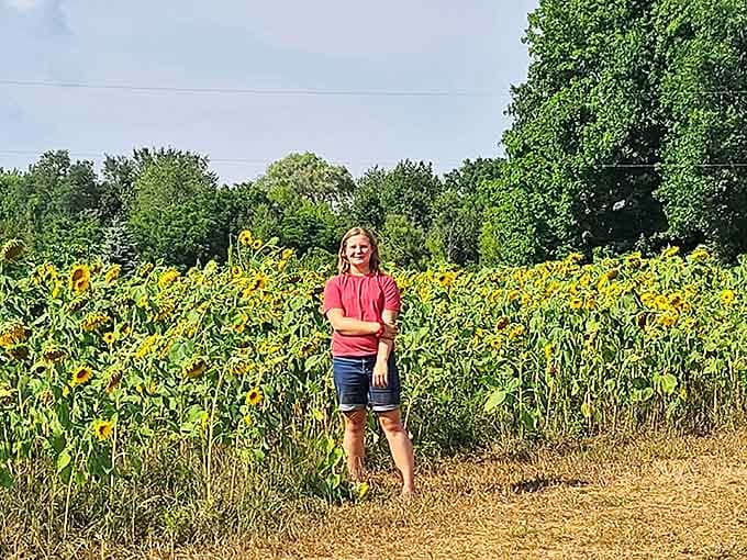 Young explorers discover the joy of nature's playground, where sunflowers create towering mazes perfect for childhood adventures.
