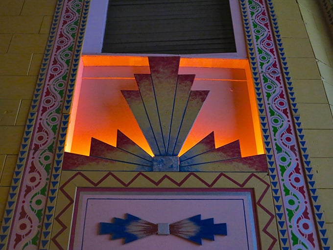 Art Deco details illuminate the walls, geometric patterns catching light and imagination like they've done for generations of film lovers.