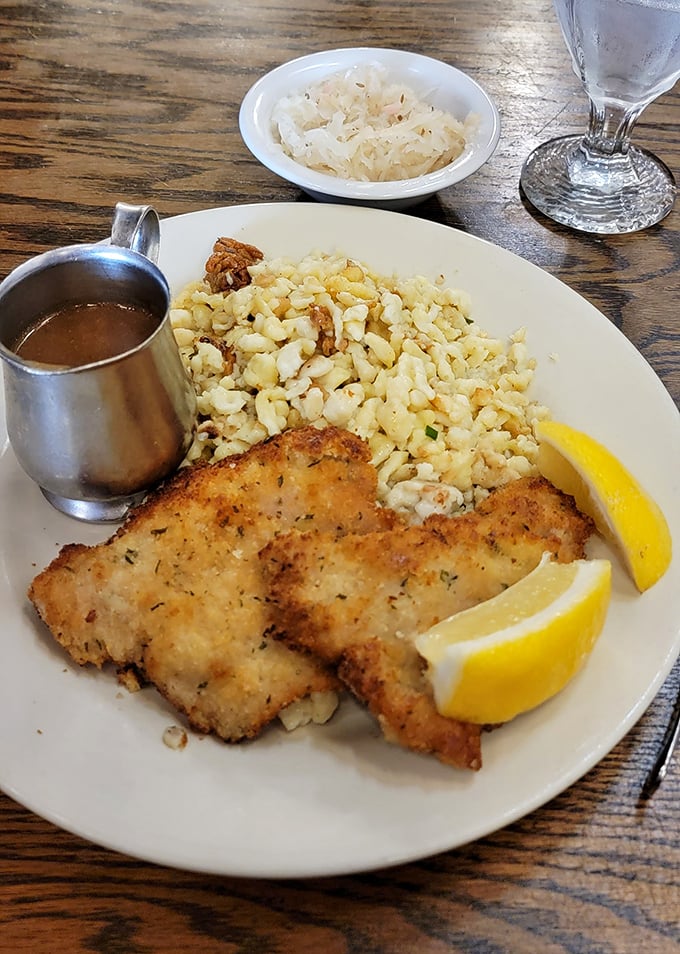 Wiener Schnitzel: Golden-brown perfection on a plate – this crispy veal cutlet with spätzle and lemon wedges is the poster child for German comfort food done right.