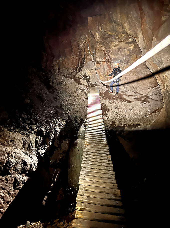 Wooden walkways suspended over seemingly bottomless chasms, because apparently regular walking paths weren't exciting enough for copper miners.