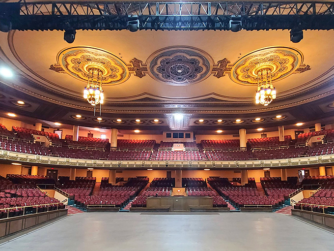 The main auditorium awaits its next 4,400 guests with plush seating and a ceiling that rivals European palaces for sheer artistic splendor.