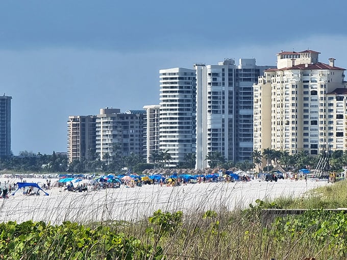 Beachfront buildings stand like sentinels guarding paradise, their residents enjoying front-row seats to nature's daily spectacle.