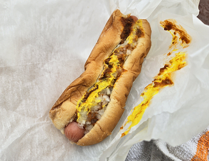 Chili, mustard, and onions cascade over this hot dog like flavor avalanches, creating the perfect balance of textures and tastes.
