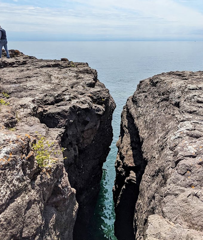 Nature's daredevil view: Standing at the edge of these ancient volcanic cliffs offers perspective on the forces that created this musical beach.