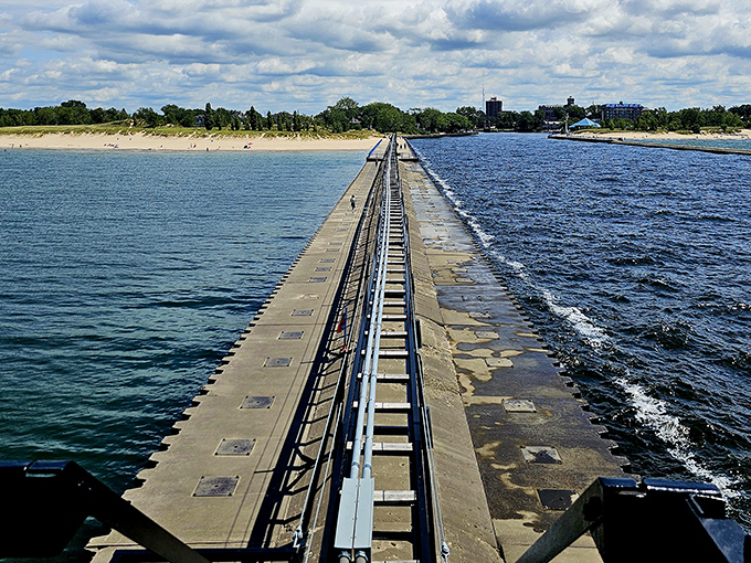 The concrete breakwater stretches toward the horizon like a runway to adventure, leading visitors straight to maritime magic.