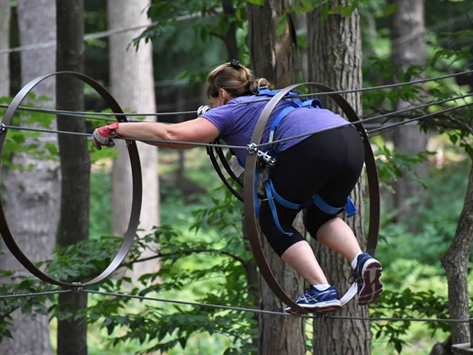 Navigating through suspended hoops requires the grace of a gymnast and the determination of someone who's paid full admission.