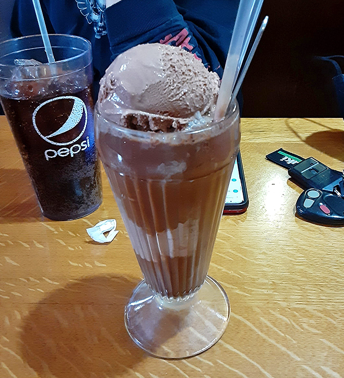 That's not just a chocolate float, it's a tower of nostalgia served in a fluted glass, demanding both straw and spoon.