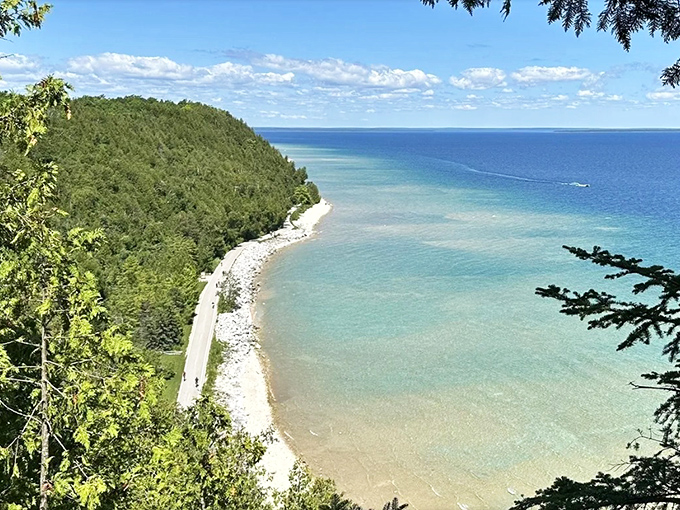 From this bluff viewpoint, the island's shoreline path resembles a delicate ribbon wrapped around nature's most perfect gift package.