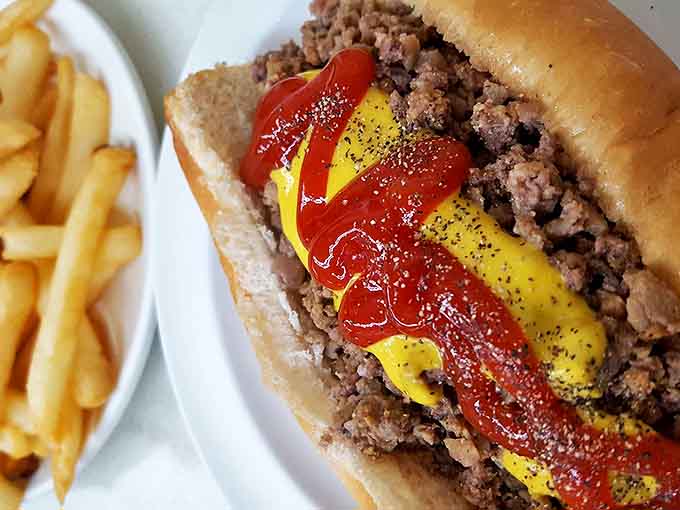 This isn't just a sandwich &ndash; it's Detroit on a plate. The loose burger combines seasoned ground beef with that legendary chili, mustard, and onions for messy perfection.