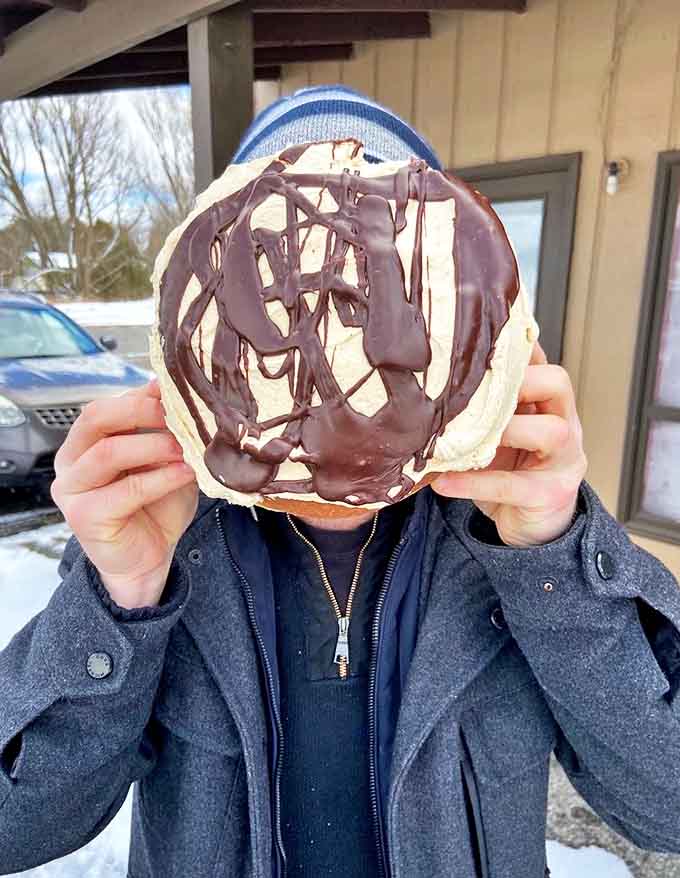 This chocolate-drizzled peanut butter donut isn't just dessert – it's an edible work of art that demands to be photographed before devouring.