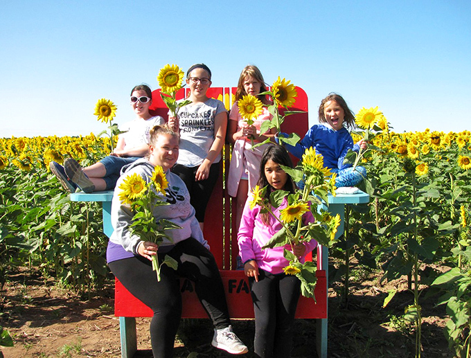 Happiness is holding a freshly cut sunflower&mdash;these smiling faces prove that simple joys make the most lasting memories.