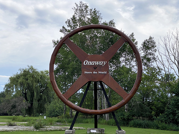 "Onaway Steers the World" proclaims this massive wheel, a nod to the town's automotive heritage that's both literal and figuratively steering visitors through history.