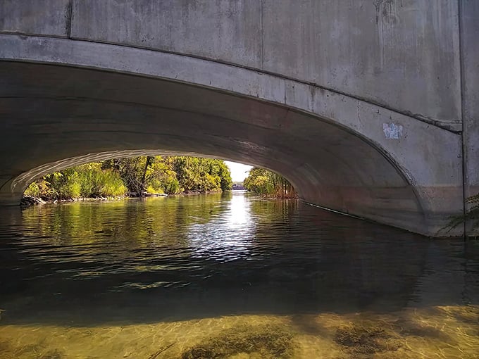 Sunlight filters through this concrete passage, creating a magical gateway between canal sections that feels worlds away from urban Detroit.