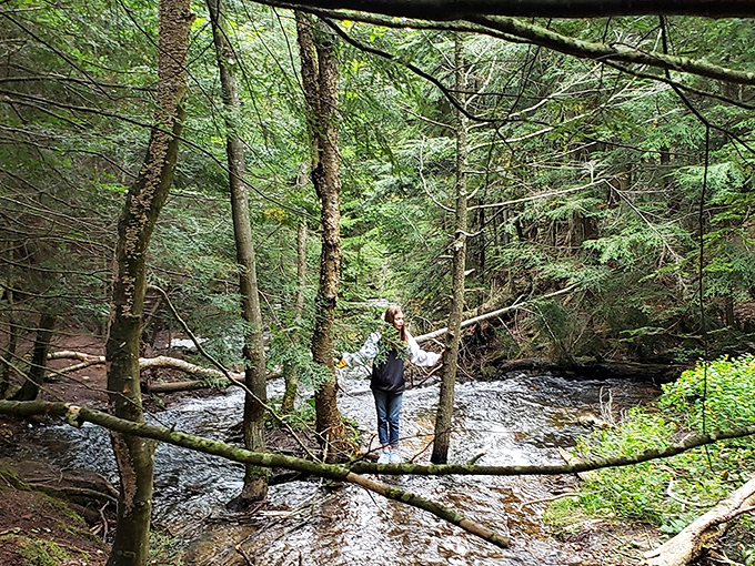 A solitary explorer pauses by the stream, perhaps contemplating how something so beautiful has remained relatively undiscovered.
