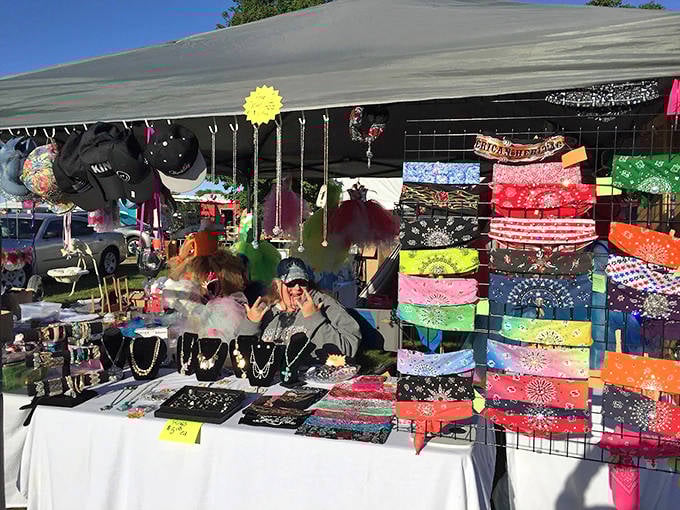 Colorful chaos of self-expression: Vibrant bandanas and handcrafted jewelry transform ordinary outfits into personal statements at this eclectic vendor's booth.