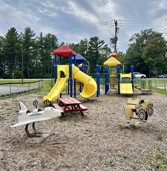 Colorful playground equipment and spring riders give the little ones their own adventure zone while parents catch their breath nearby.