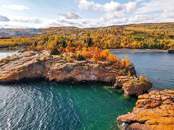 The aerial view reveals nature's perfect color combination of russet trees and rugged cliffs.