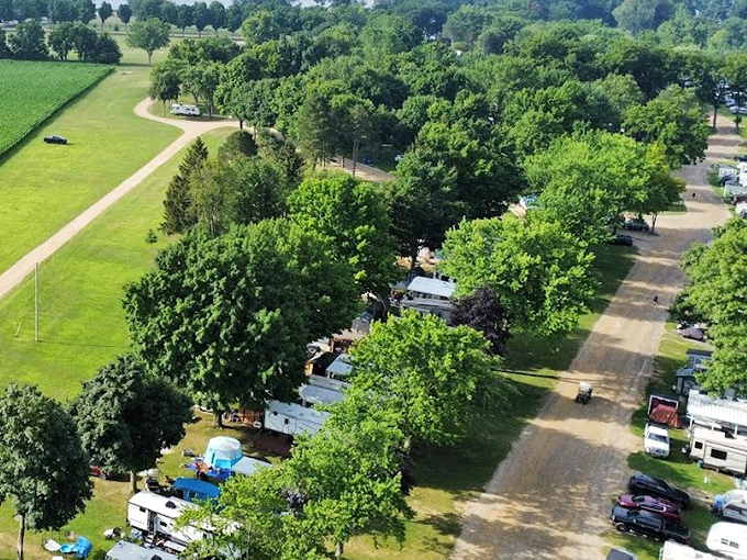 The campground stretches like a friendly neighborhood along the water's edge, each site a temporary address for summer memories.