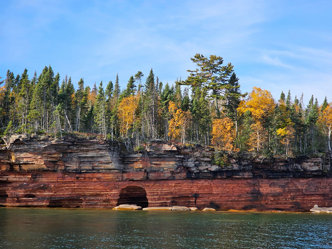 Fall foliage creates nature's perfect painting along the sandstone cliffs, where every curve in the road reveals another masterpiece.