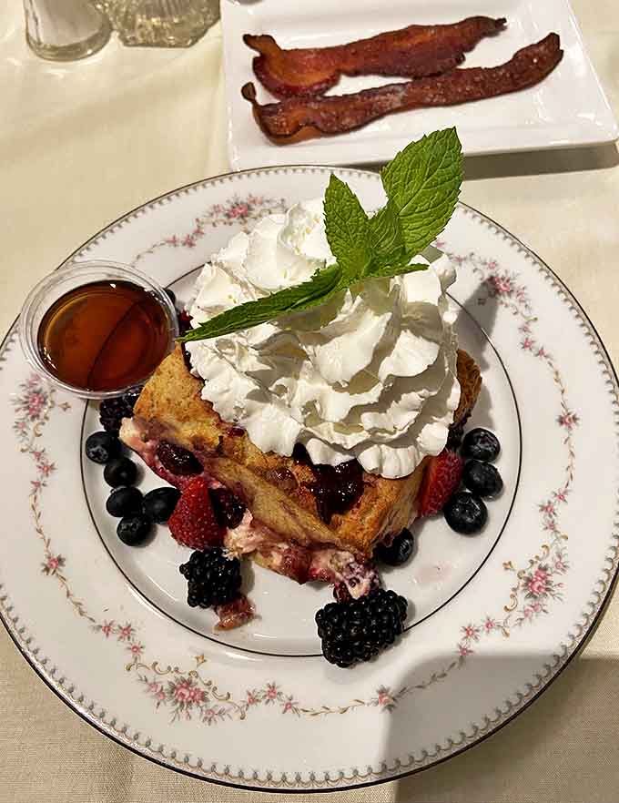 Breakfast reimagined: Berry-stuffed French toast crowned with fresh berries and whipped cream &ndash; morning indulgence that's worth setting an alarm for.