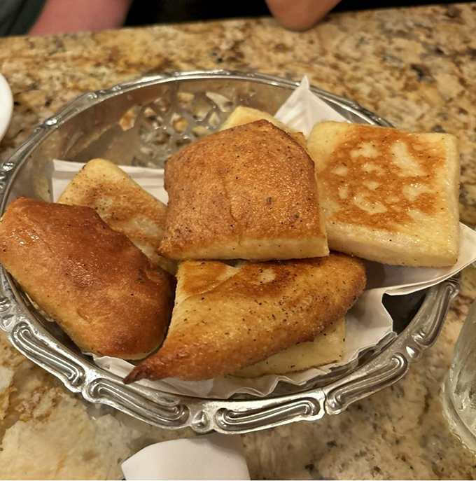The house-made bread basket – a dangerous temptation that arrives warm and fragrant, threatening to ruin appetites before main courses appear.