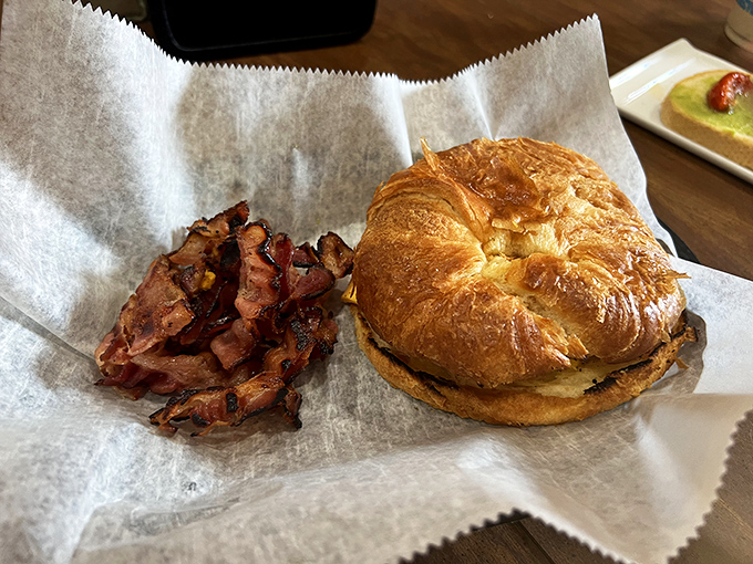 That croissant isn't just holding a breakfast sandwich, it's cradling your morning happiness in layers of buttery, flaky perfection.