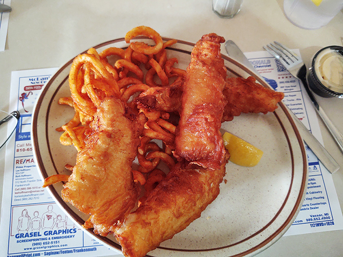 Golden-battered fish that shatters with each bite, served alongside crispy fries – proof that simple food done right is culinary magic.
