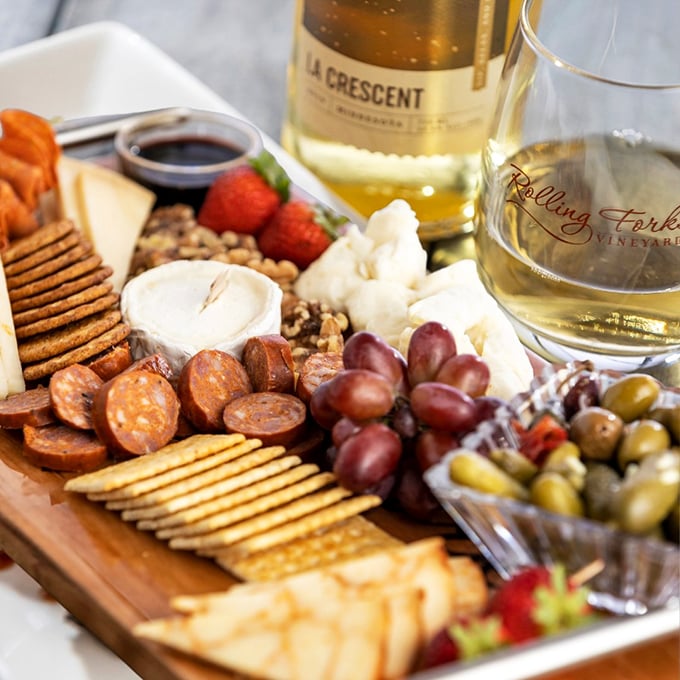 This charcuterie board delivers more delicious variety than most people's entire weekly meal plan, and pairs beautifully with literally everything they're pouring.