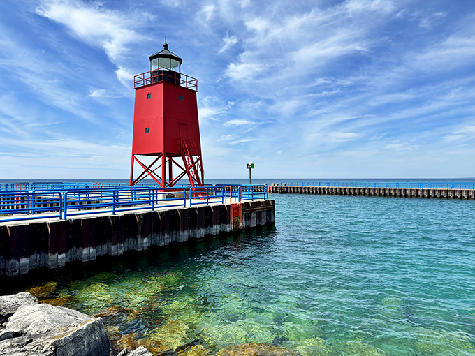 The Charlevoix South Pier Lighthouse stands like a cherry-red exclamation point against Lake Michigan's azure waters.