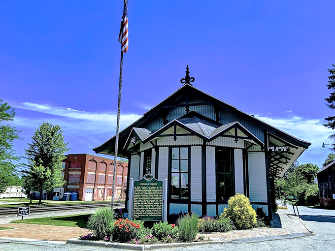 The Chelsea Depot preserves railroad history in Victorian splendor, its white trim and American flag telling stories of journeys past.